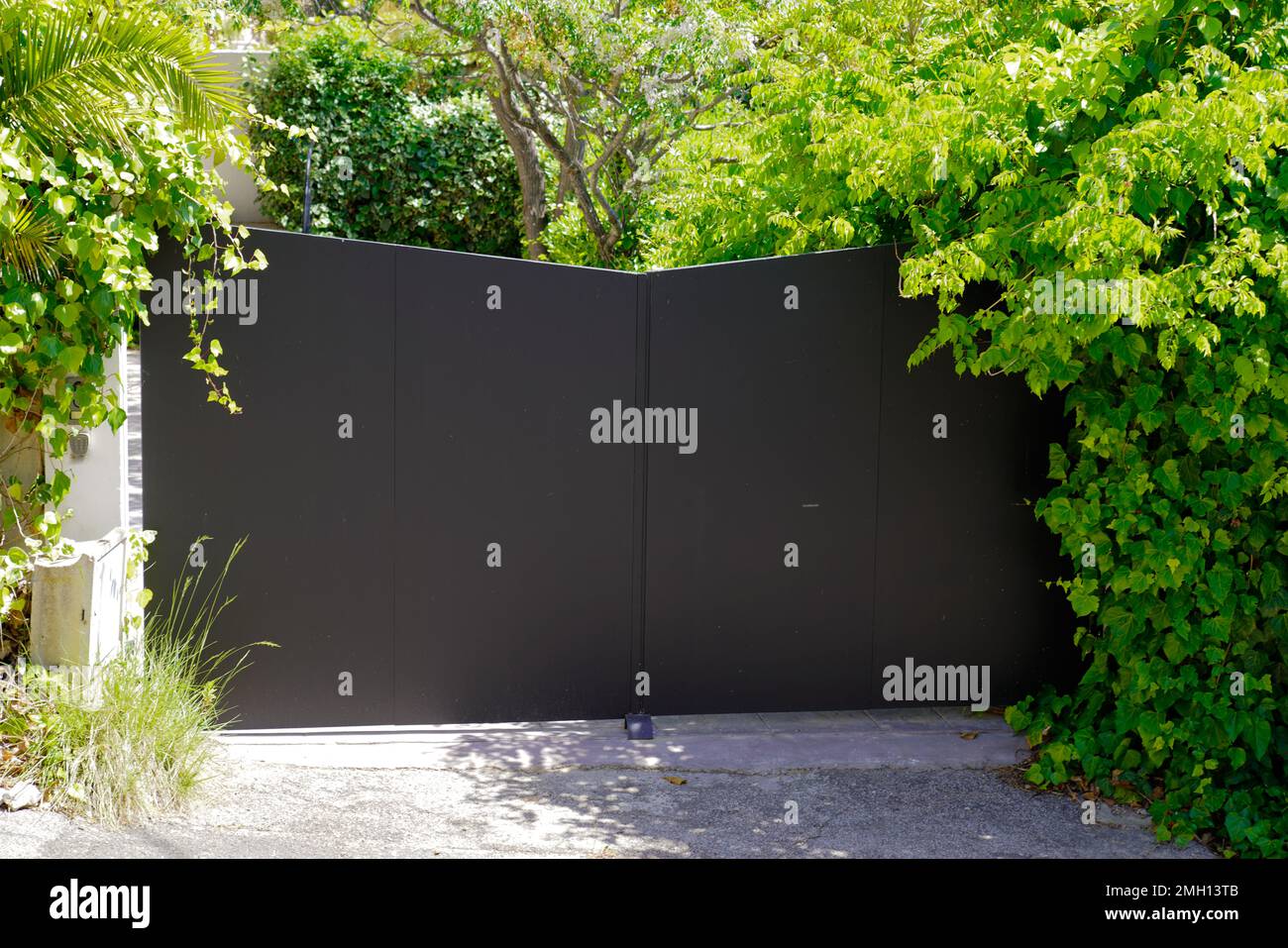 Aluminum door home in dark gray gate portal of suburb house Stock Photo ...