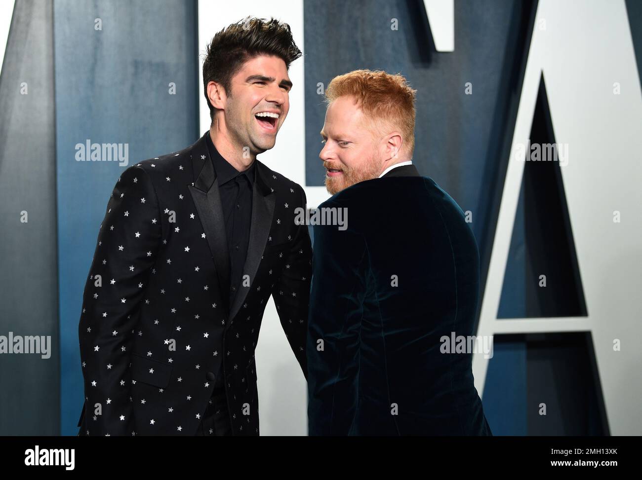 Justin Mikita, left, and Jesse Tyler Ferguson arrive at the Vanity Fair ...
