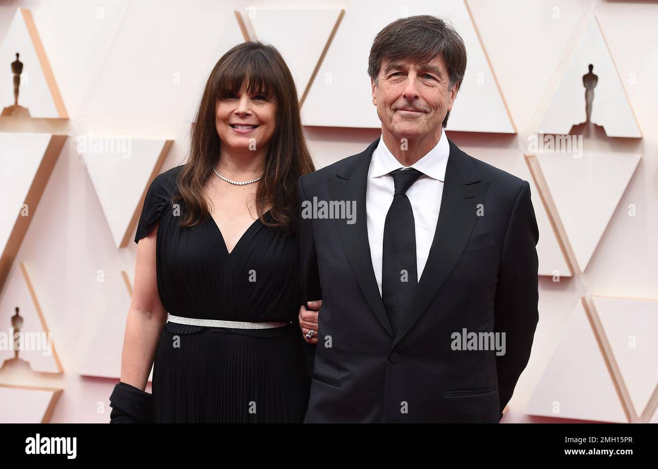 Ann Marie Zirbes, left, and Thomas Newman arrive at the Oscars on ...