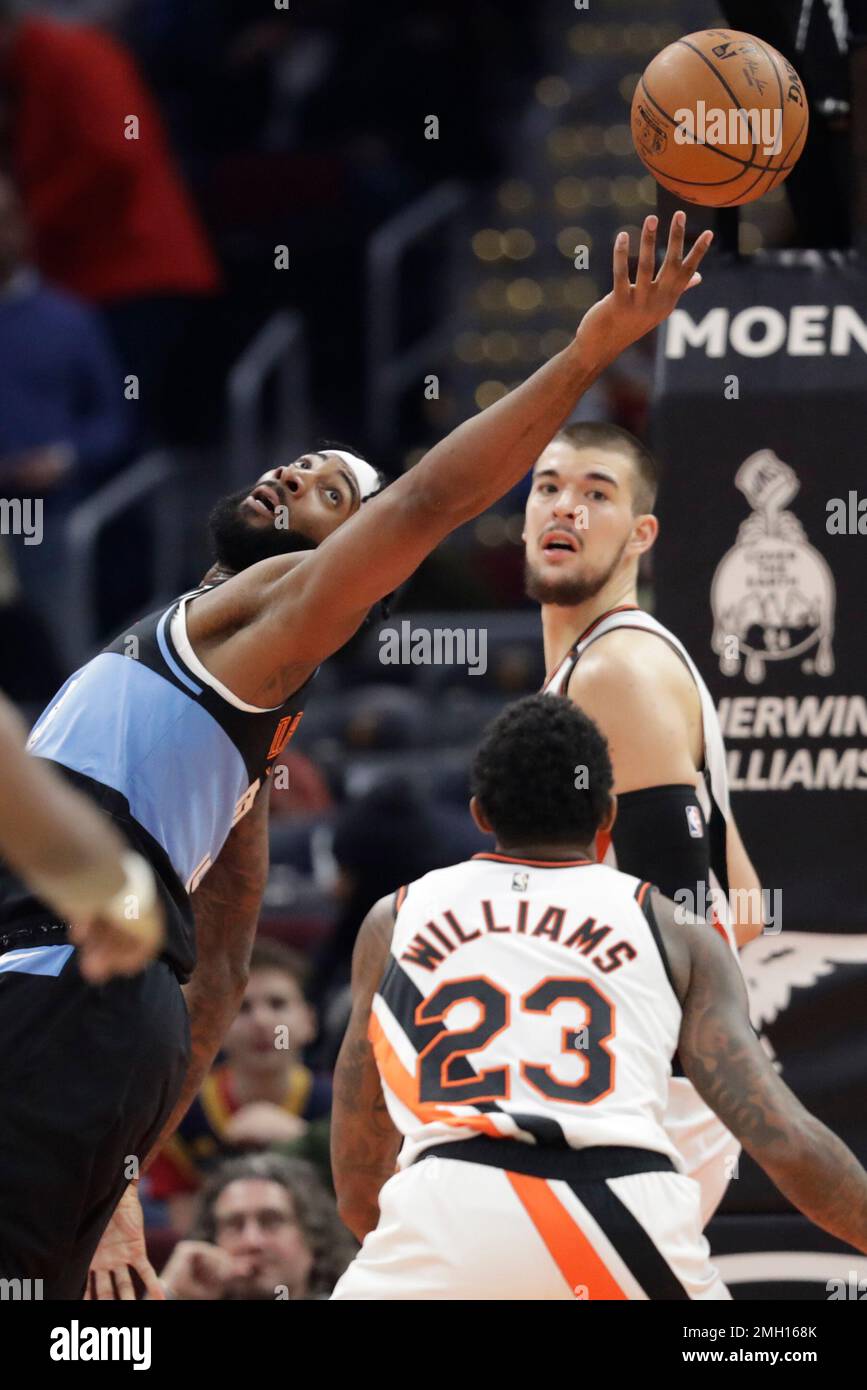 Cleveland Cavaliers' Andre Drummond, left, reaches for a rebound in the ...