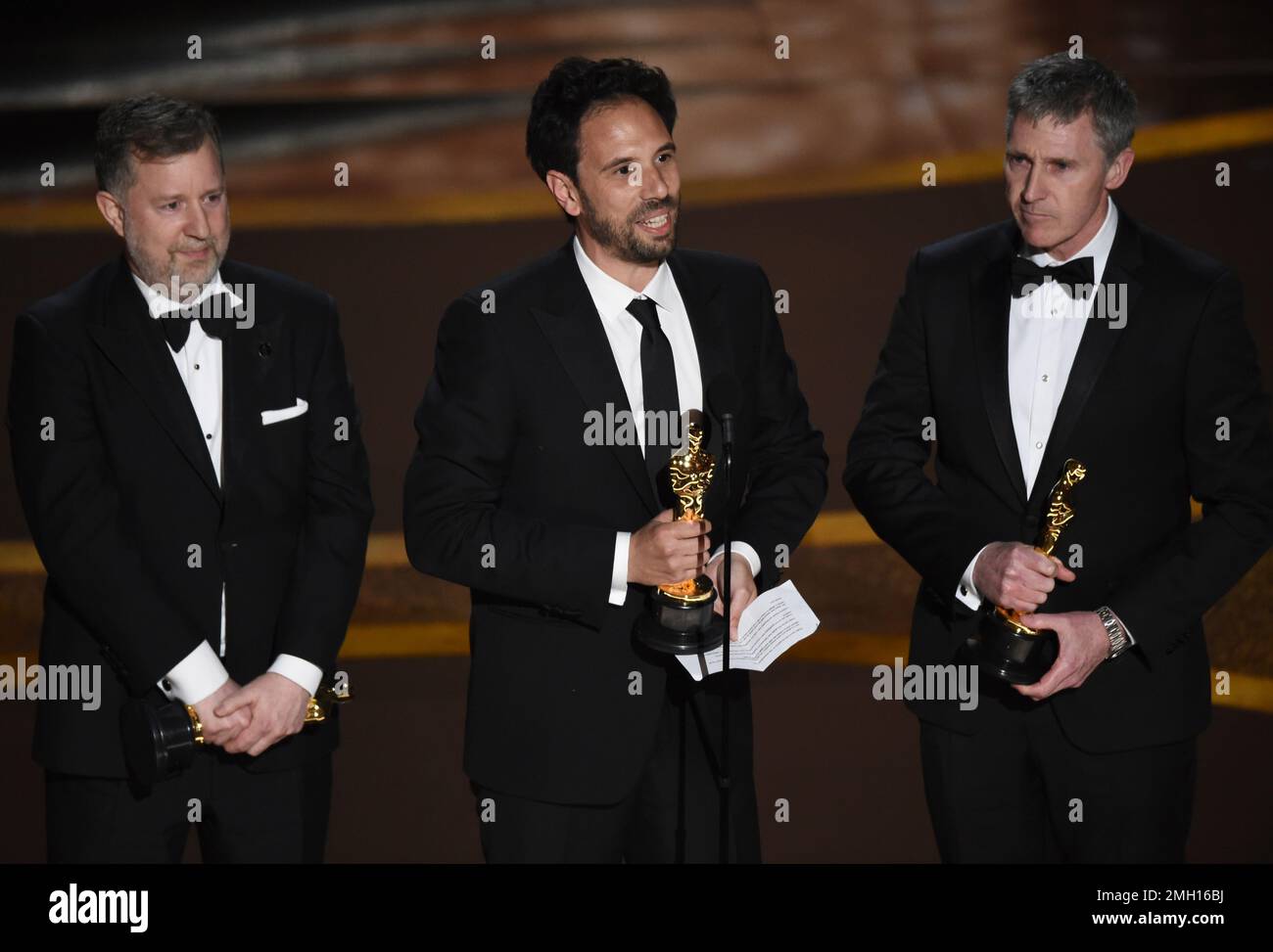 Greg Butler, from left, Guillaume Rocheron and Dominic Tuohy accept the ...