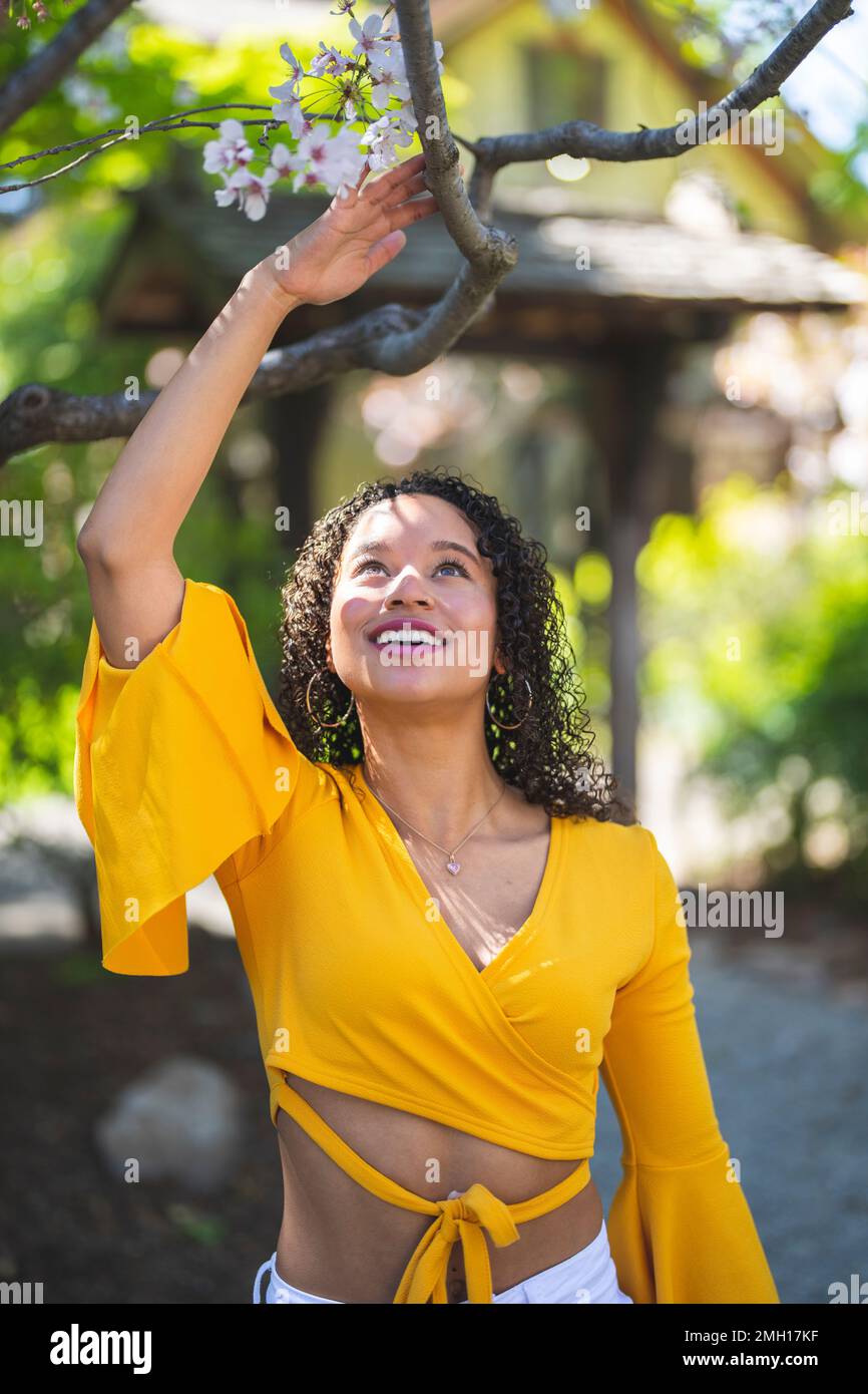 Beautiful Young African American Woman Playing Around Under Blossoming ...