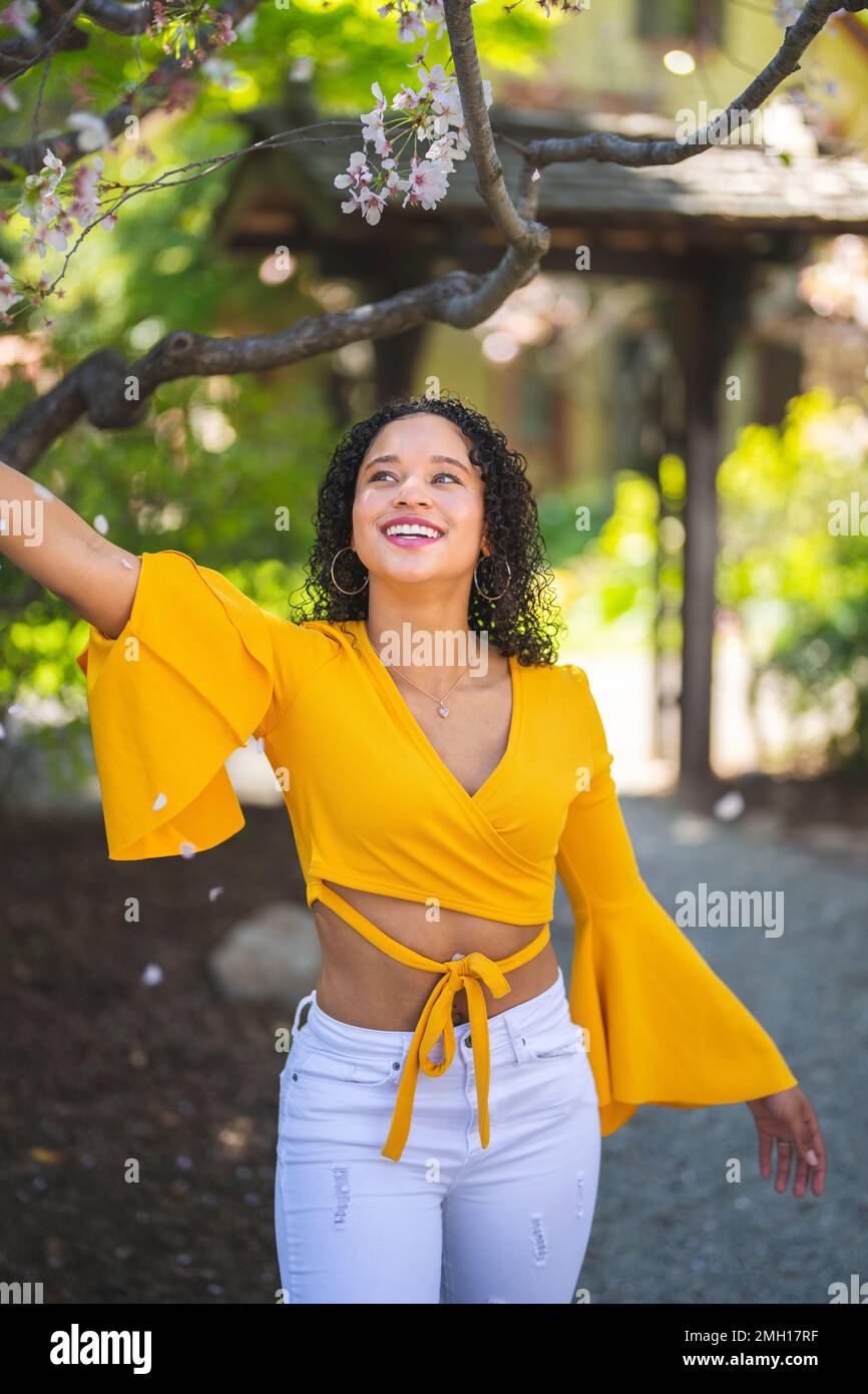 Beautiful Young African American Woman Playing Around Under Blossoming ...