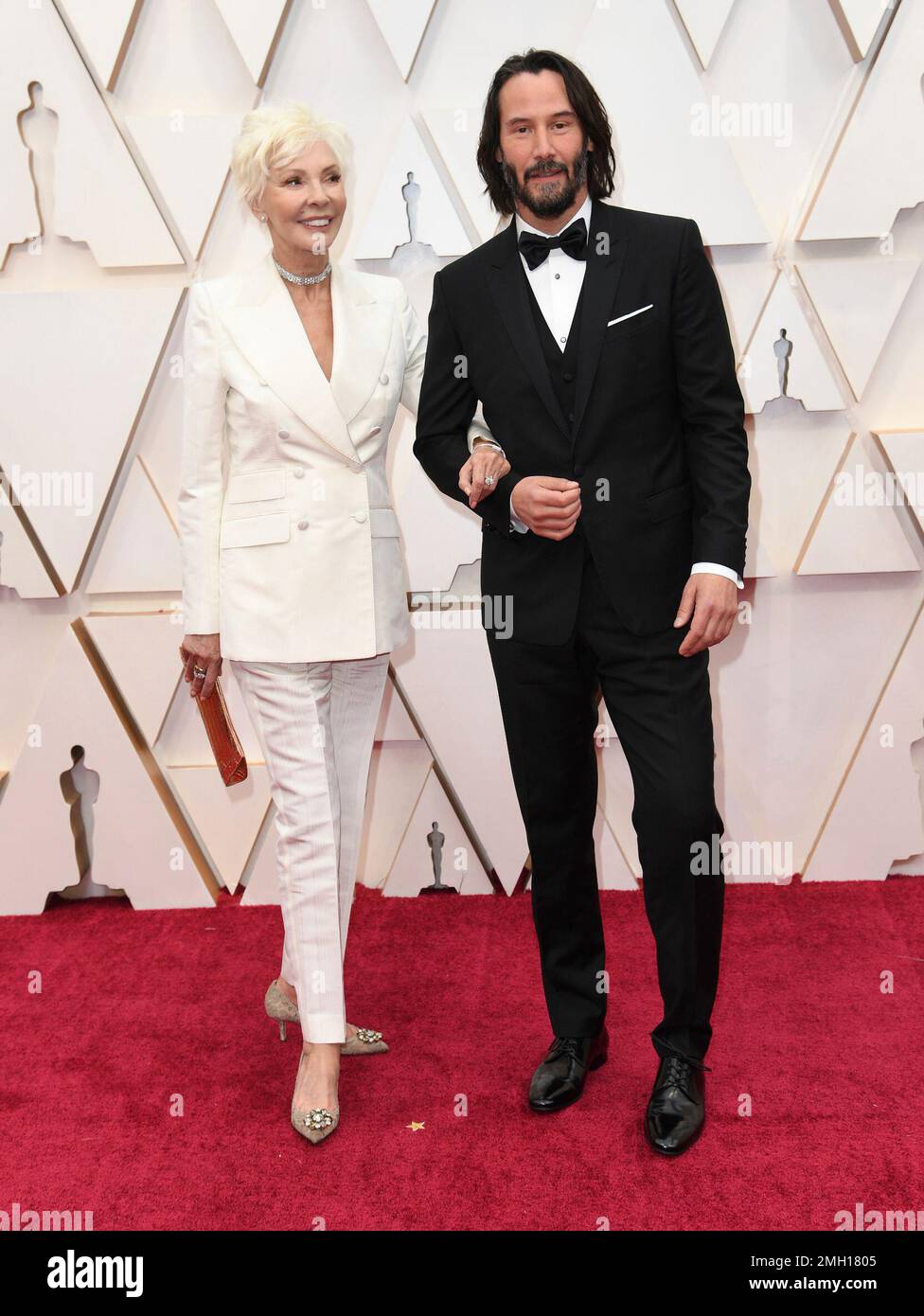 Patricia Taylor, left, and Keanu Reeves arrive at the Oscars on Sunday ...