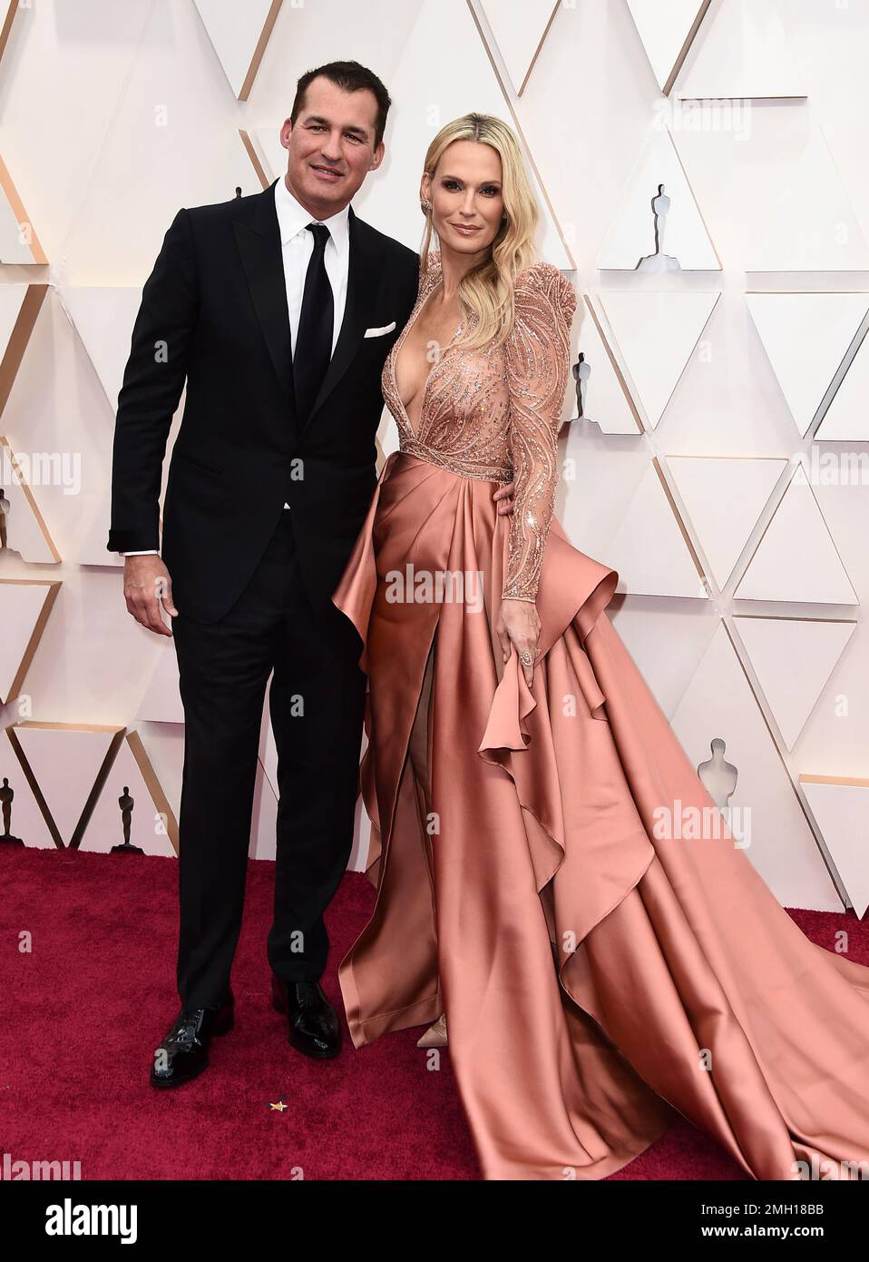 Scott Stuber, left, and Molly Sims arrive at the Oscars on Sunday, Feb ...
