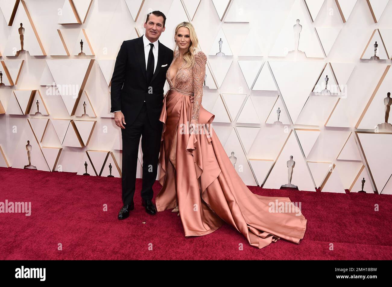 Scott Stuber, left, and Molly Sims arrive at the Oscars on Sunday, Feb ...