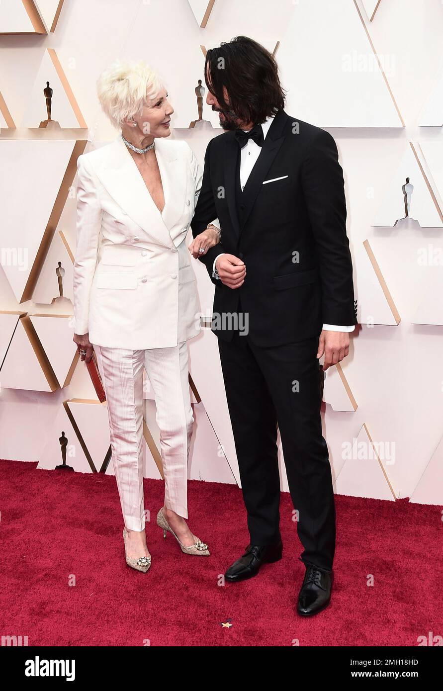 Patricia Taylor, left, and Keanu Reeves arrive at the Oscars on Sunday ...