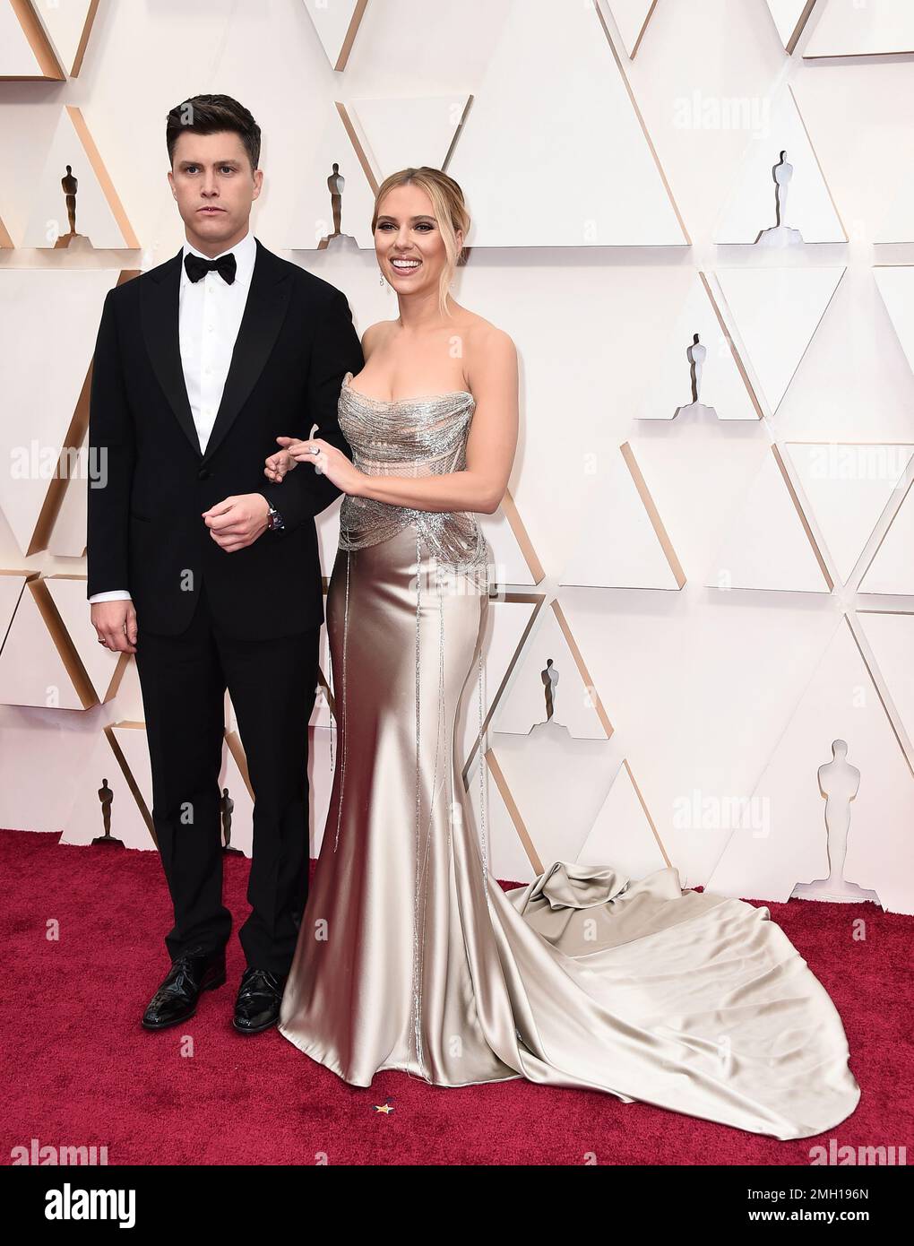 Colin Jost, left, and Scarlett Johansson arrive at the Oscars on Sunday ...