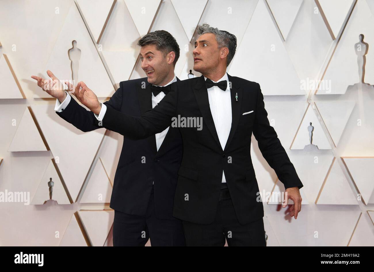 Carthew Neal, left, and Taika Waititi arrive at the Oscars on Sunday ...