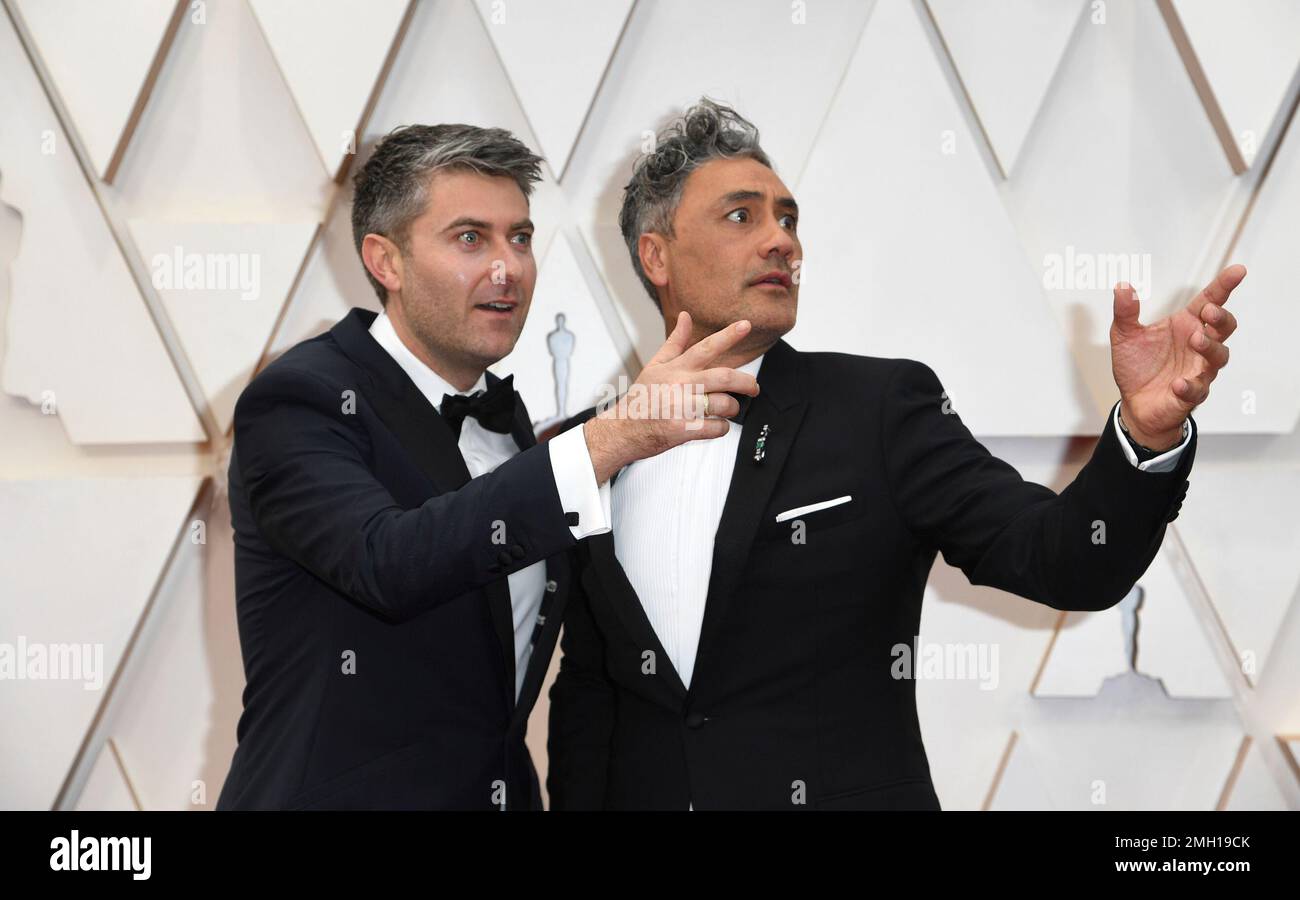 Carthew Neal, left, and Taika Waititi arrive at the Oscars on Sunday ...