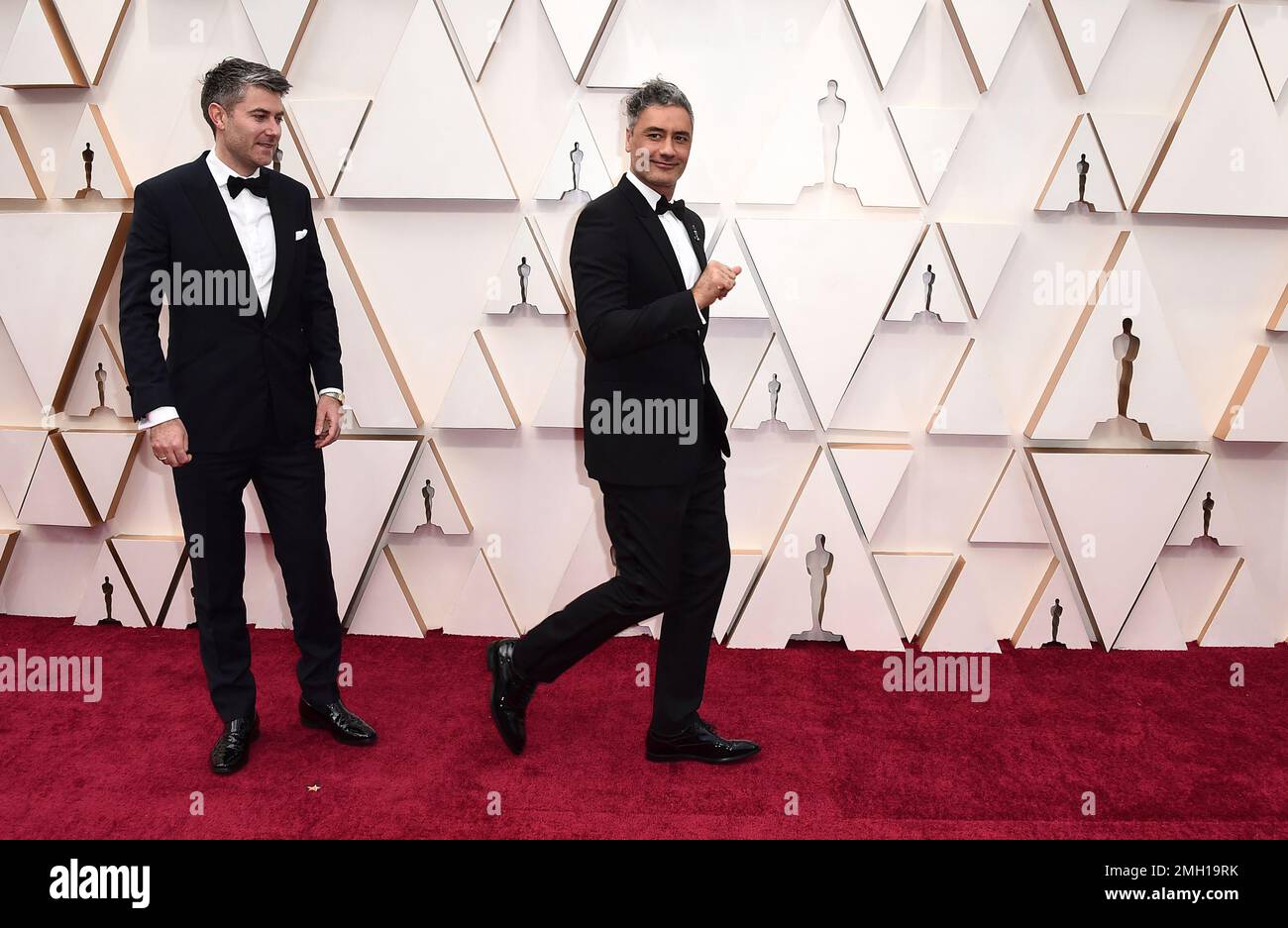 Carthew Neal, left, and Taika Waititi arrive at the Oscars on Sunday ...