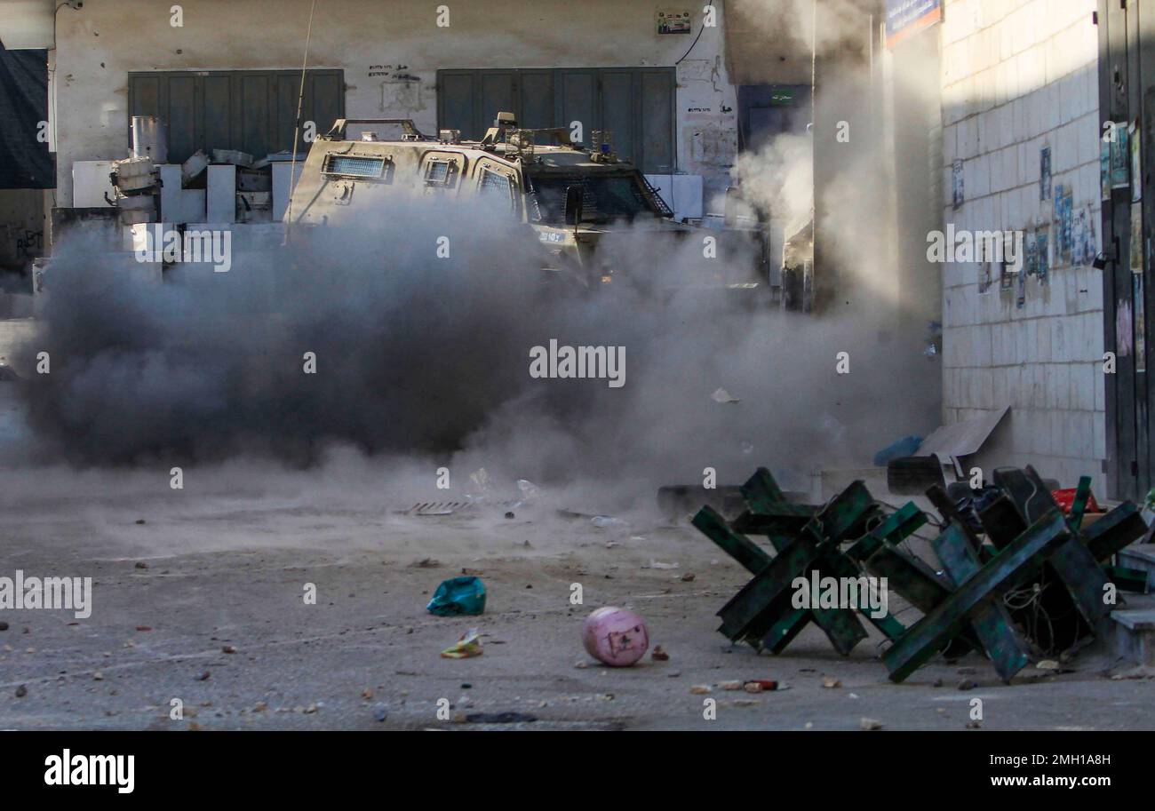 Thick smoke rises near an Israeli military vehicle, after a homemade ...