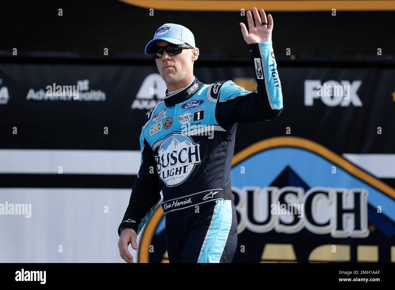 Kevin Harvick waves to fans before the NASCAR Busch Clash auto race at ...