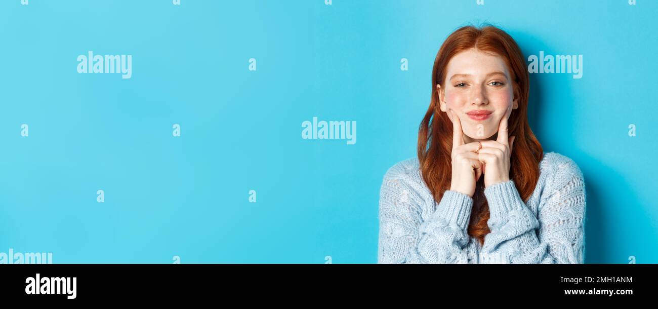 Close Up Of Cute And Silly Girl With Red Hair Poking Cheeks Showing Dimples And Smiling