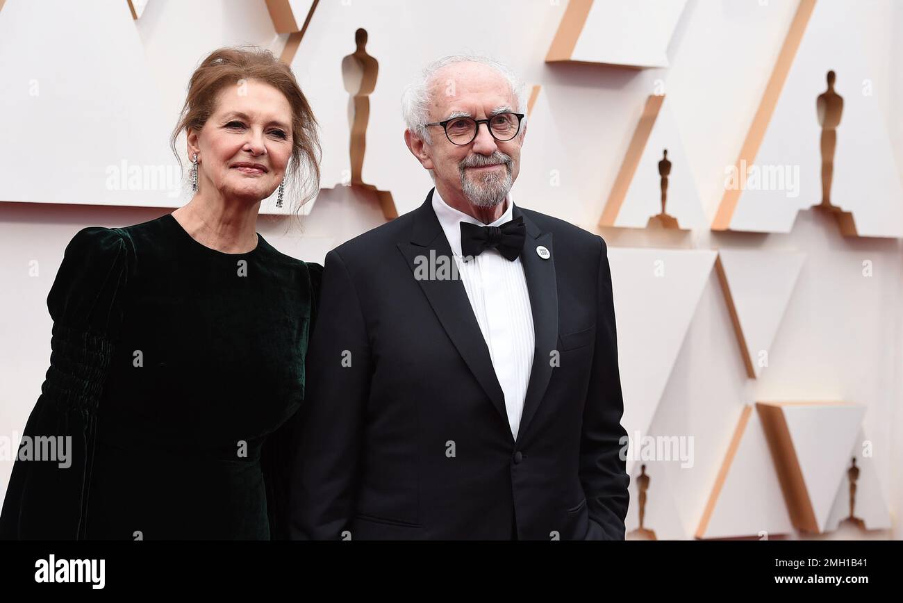 Kate Fahy, left, and Jonathan Pryce arrive at the Oscars on Sunday, Feb ...