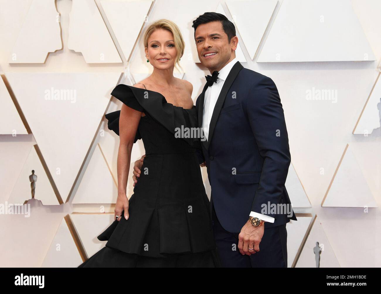 Kelly Ripa, left, and Mark Consuelos arrive at the Oscars on Sunday ...