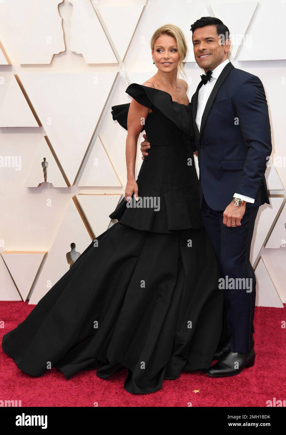 Kelly Ripa, left, and Mark Consuelos arrive at the Oscars on Sunday ...