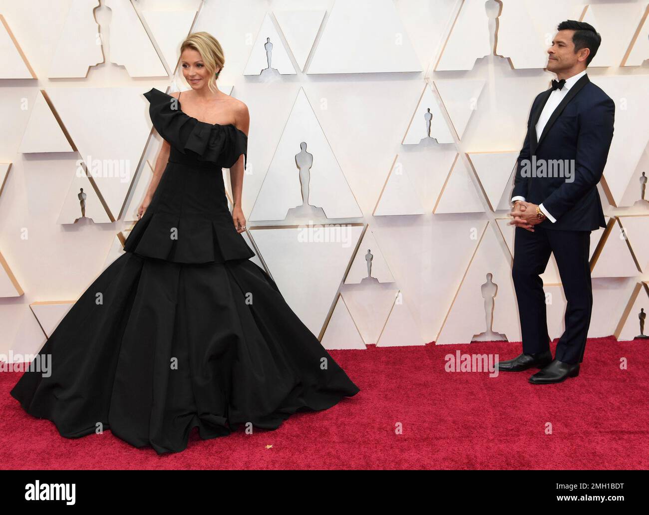 Kelly Ripa, left, and Mark Consuelos arrive at the Oscars on Sunday ...