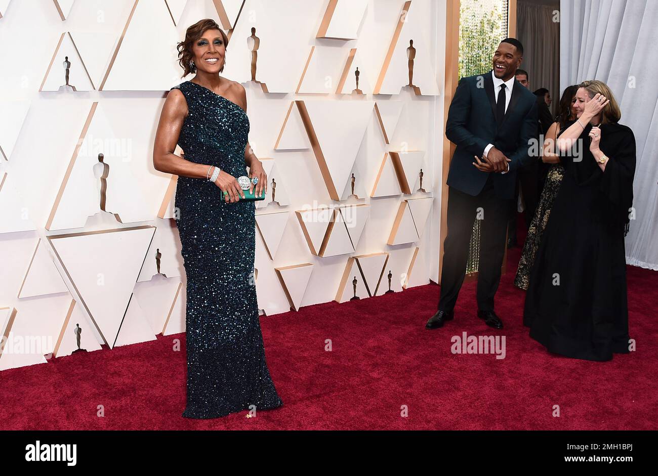 Michael Strahan, right, looks on as Robin Roberts, left, arrives at the ...