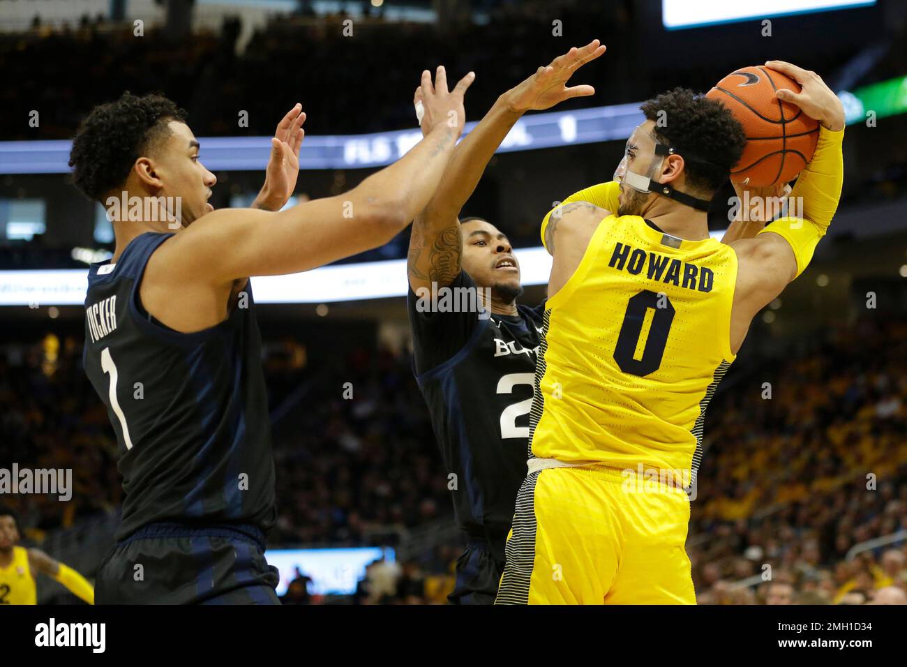 Marquette's Markus Howard (0) looks to pass while pressured by Butler ...