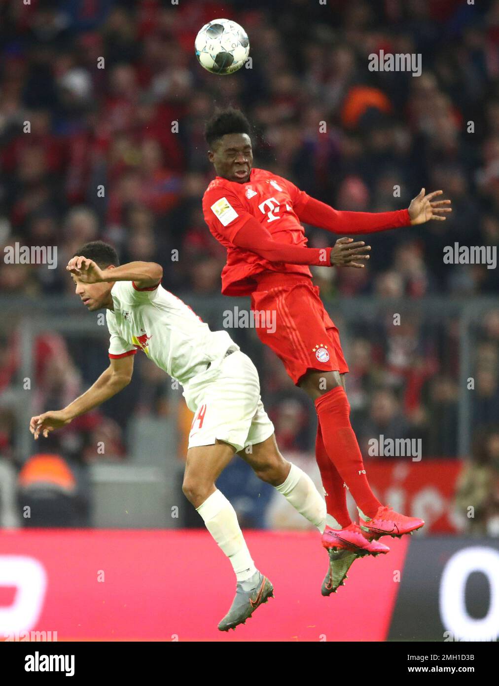 Leipzig's Tyler Adams, left, and Bayern's Alphonso Davies challenge for ...