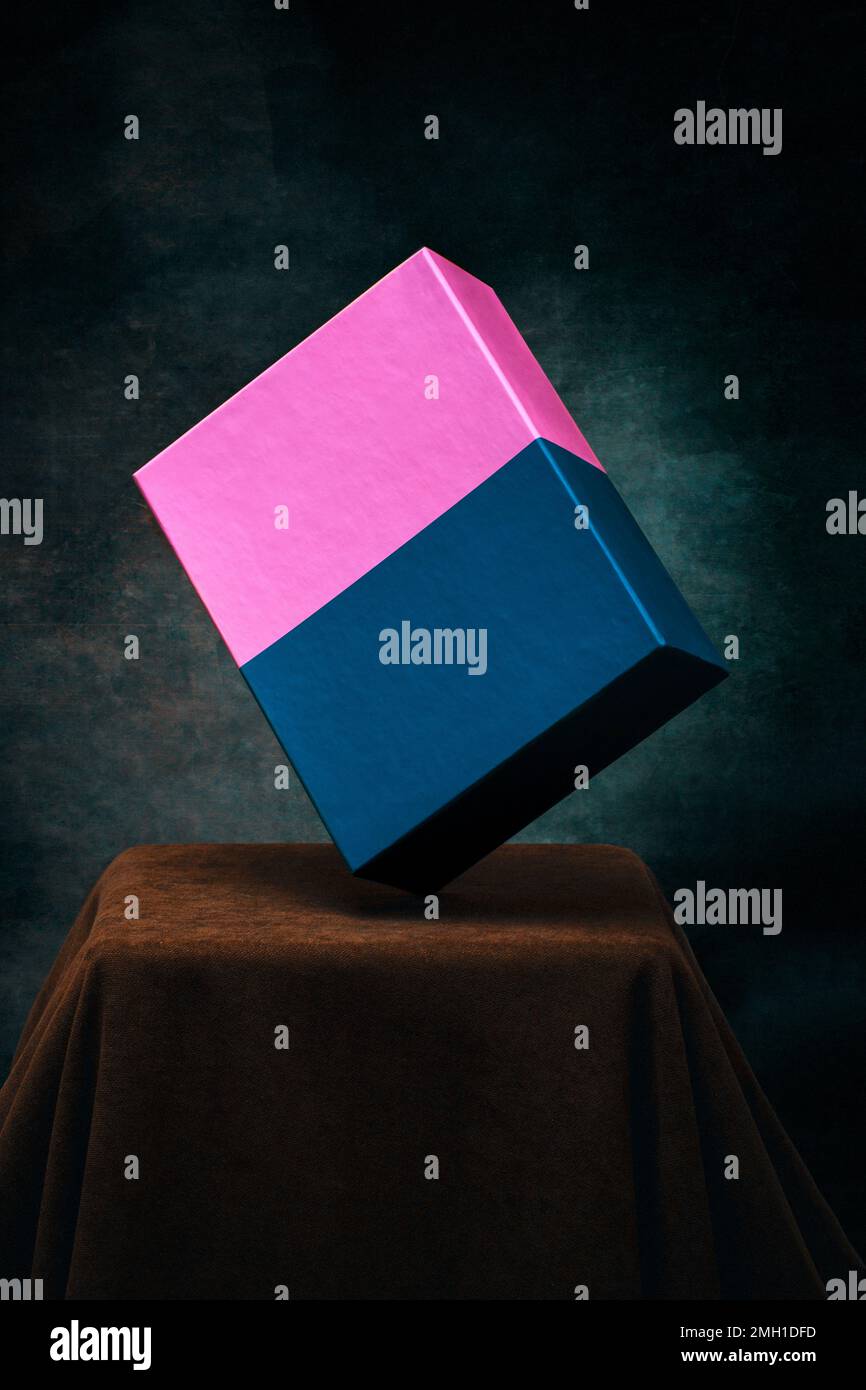Still life with a blue-pink box on a brown table Stock Photo - Alamy