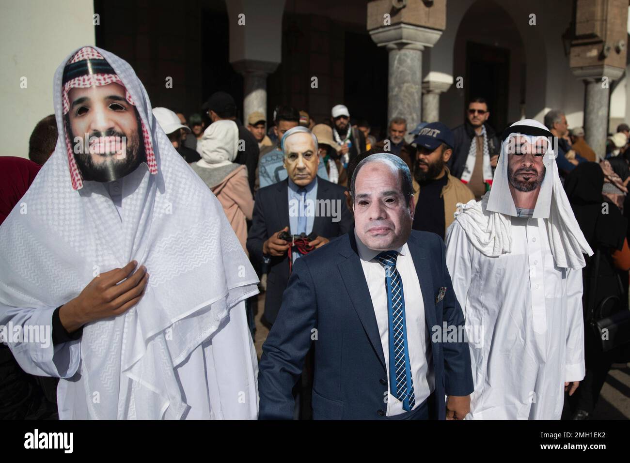 People wear masks depicting foreground right, Dubai Crown Prince Sheikh ...