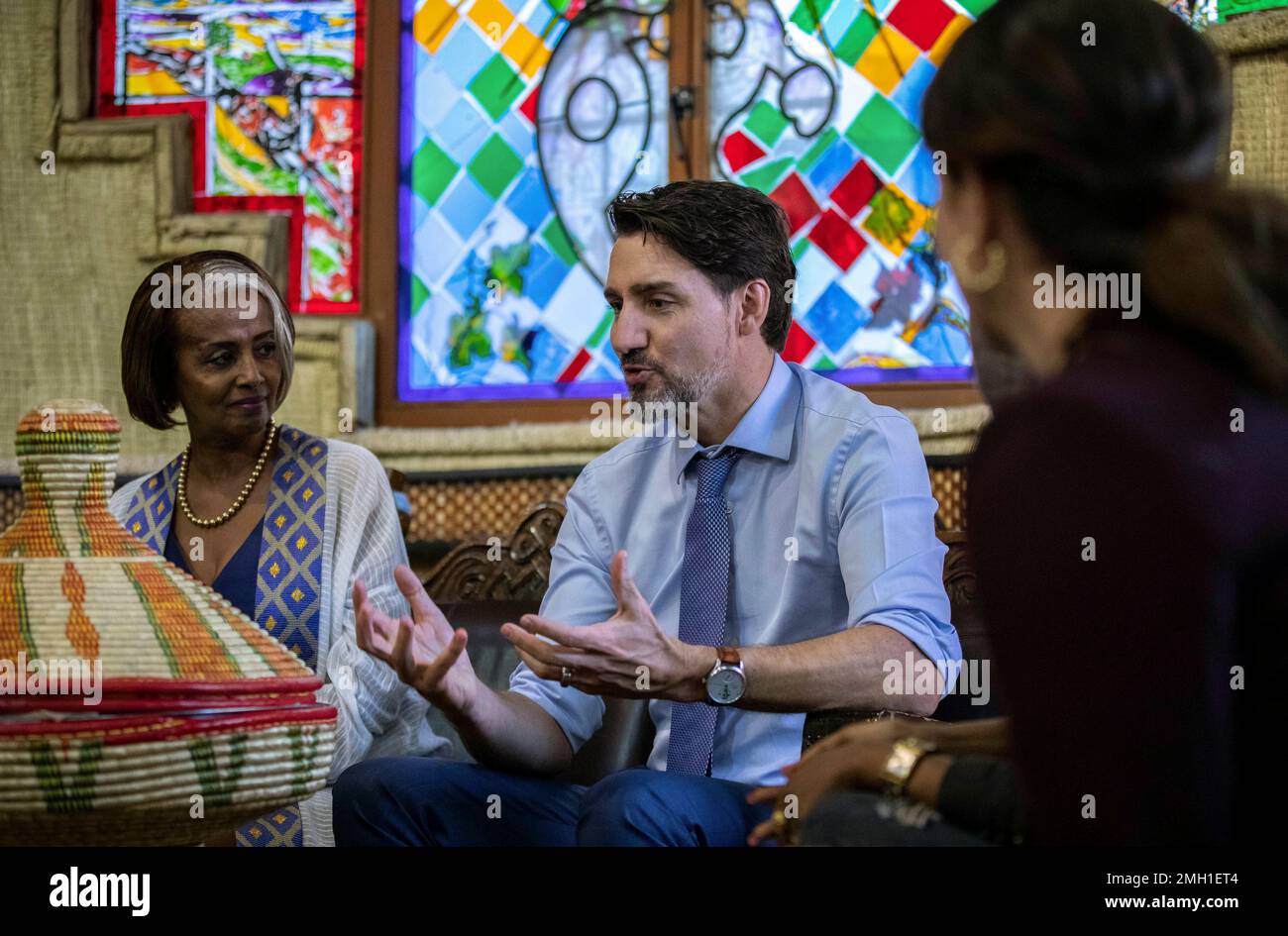 Canada's Prime Minister Justin Trudeau, center, sits with Samrawit ...