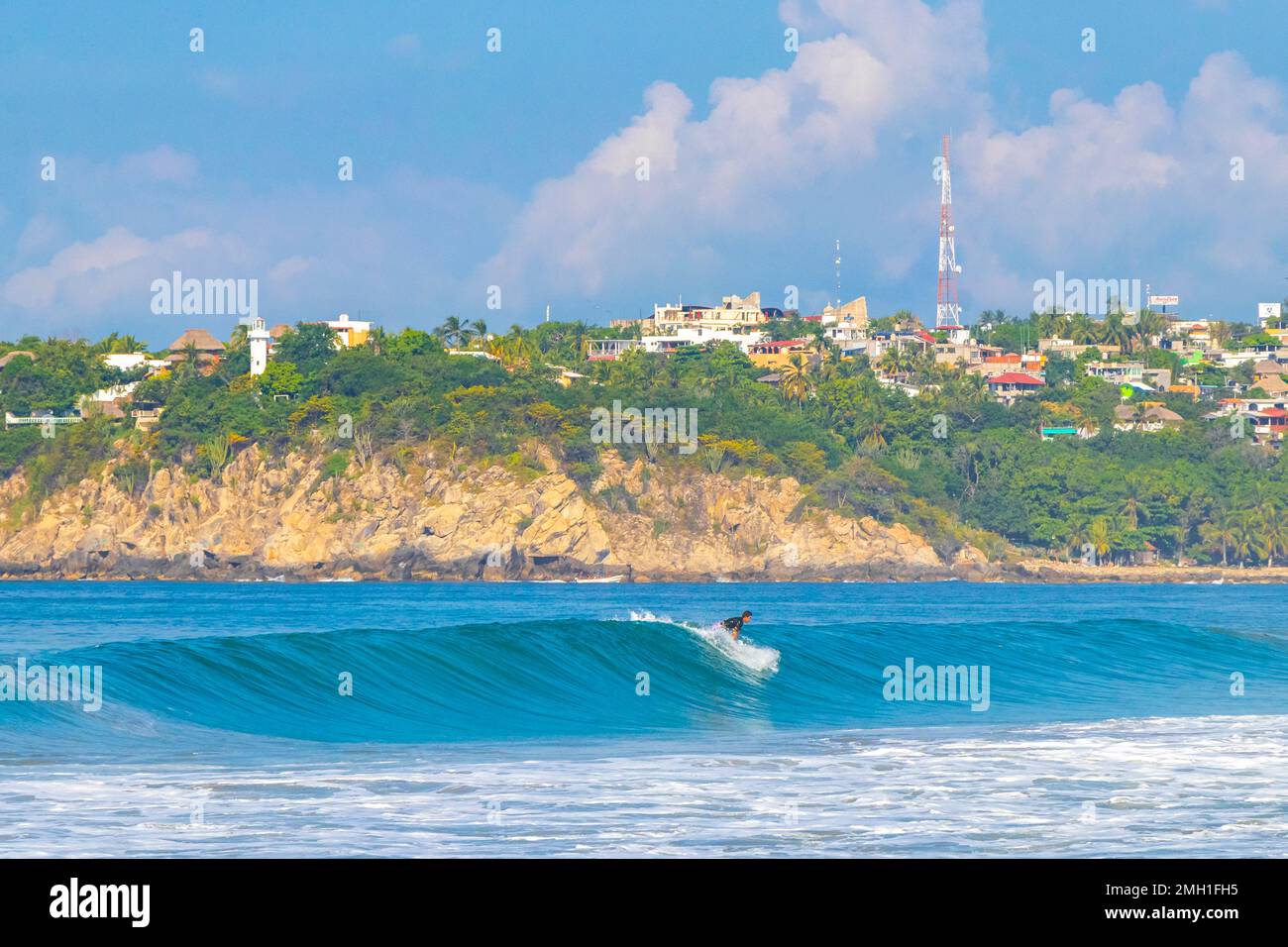 Surfer surfing on surfboard on high waves in Zicatela Puerto Escondido ...