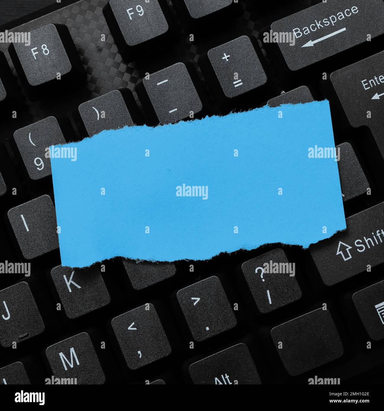 Colored sticker lying on black keyboard. Important information written ...