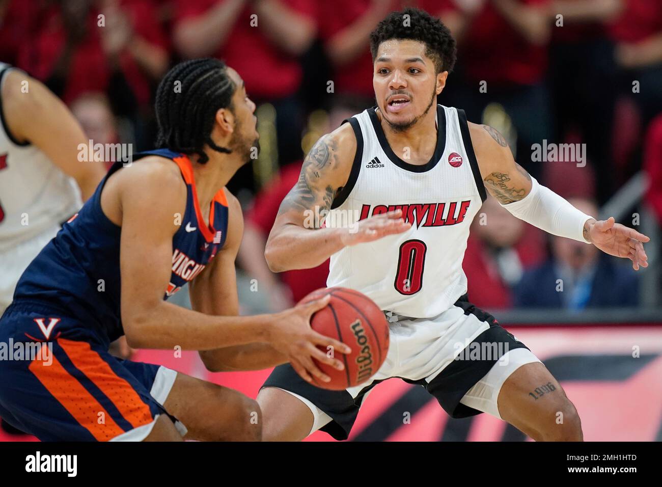 Louisville guard Lamarr Kimble (0) defends against Virginia guard Tomas ...