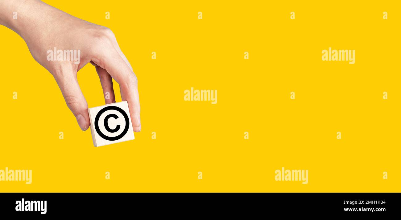 Copyright sign, symbol in hand, banner. Intellectual property ...
