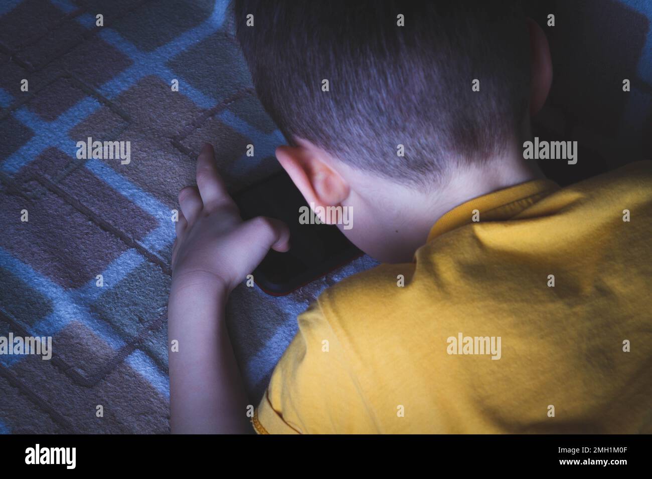 Phone in hands of child. Little boy playing mobile games on smartphone ...