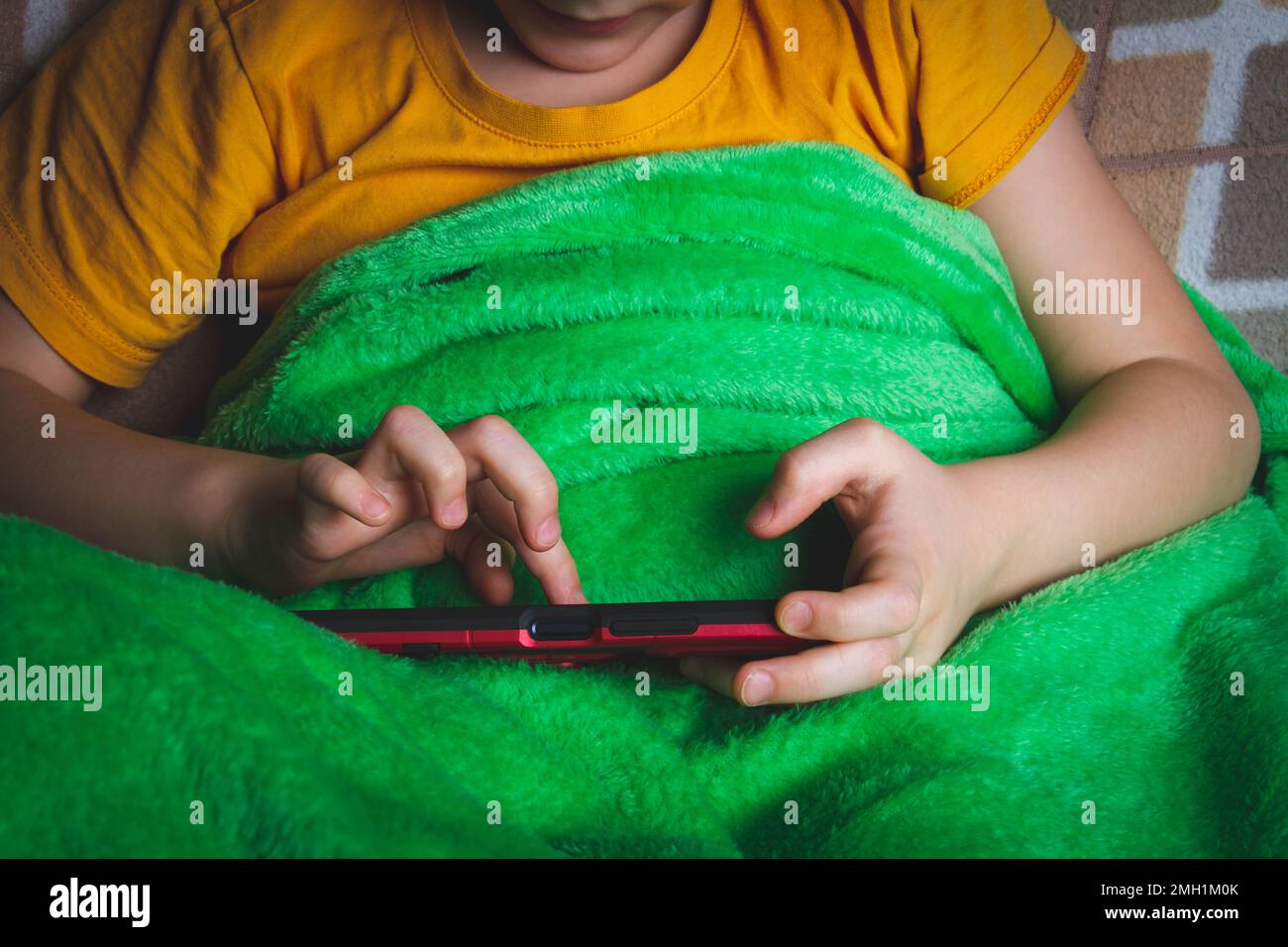 Phone in hands of child. Little boy playing mobile games on smartphone ...