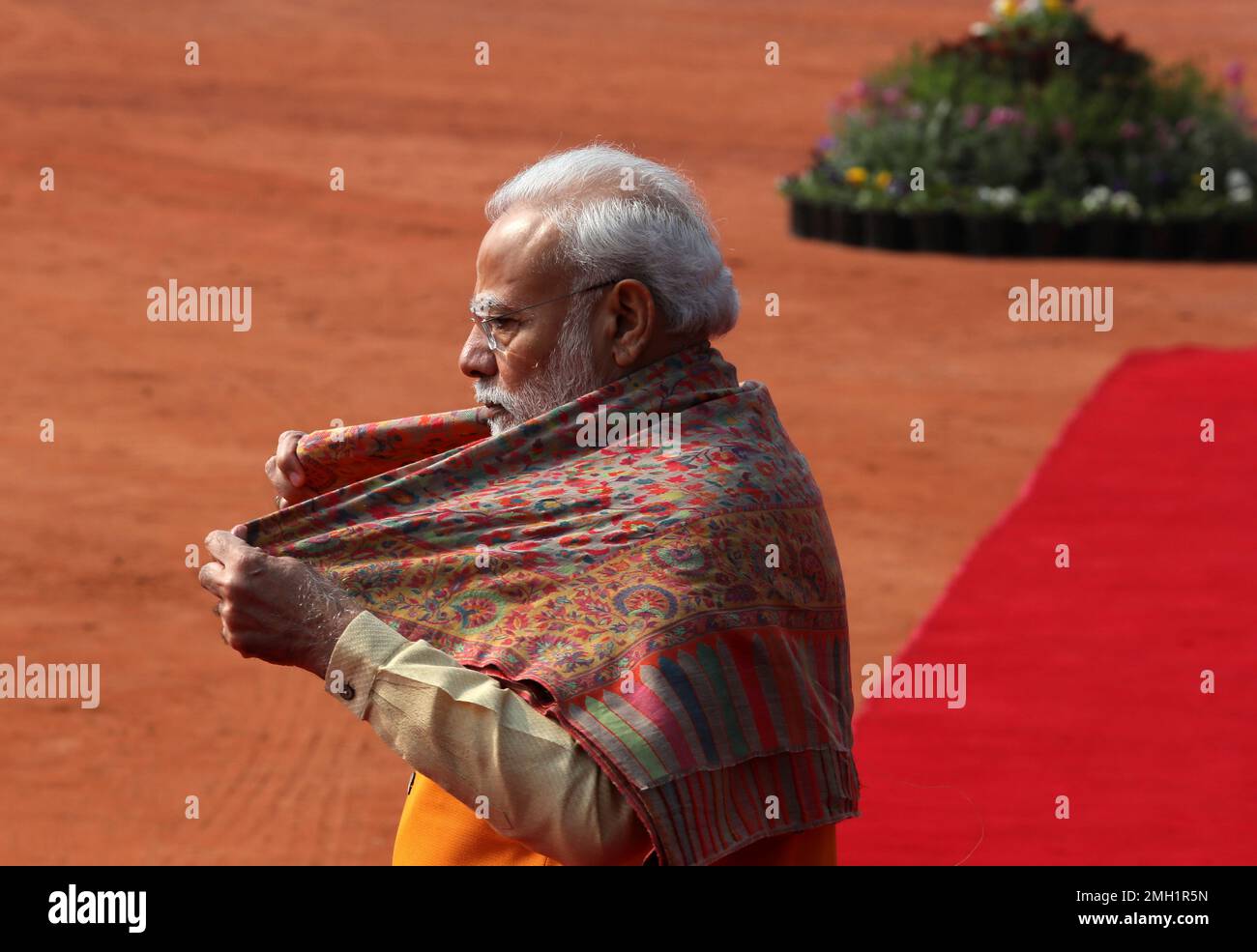 Indian Prime Minister Narender Modi adjust his shawl as he waits to ...