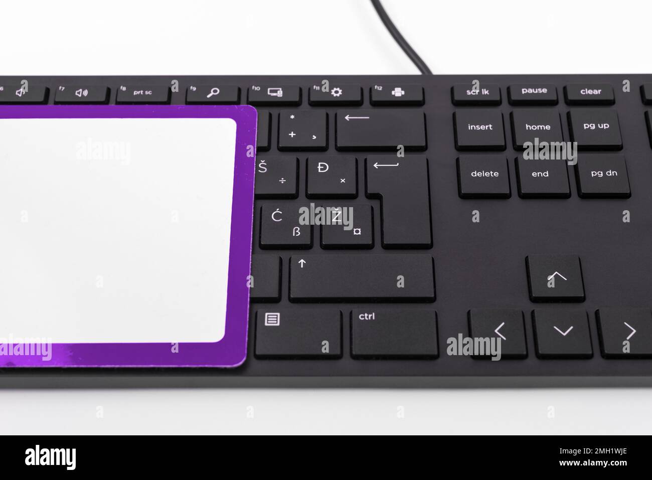 Colored paper with important message lying desk near keyboard. Main ...