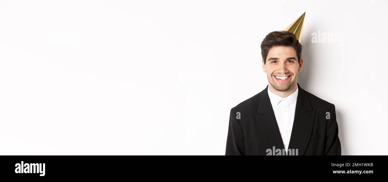 Close Up Of Handsome Happy Man In Suit And Party Hat Smiling Joyful