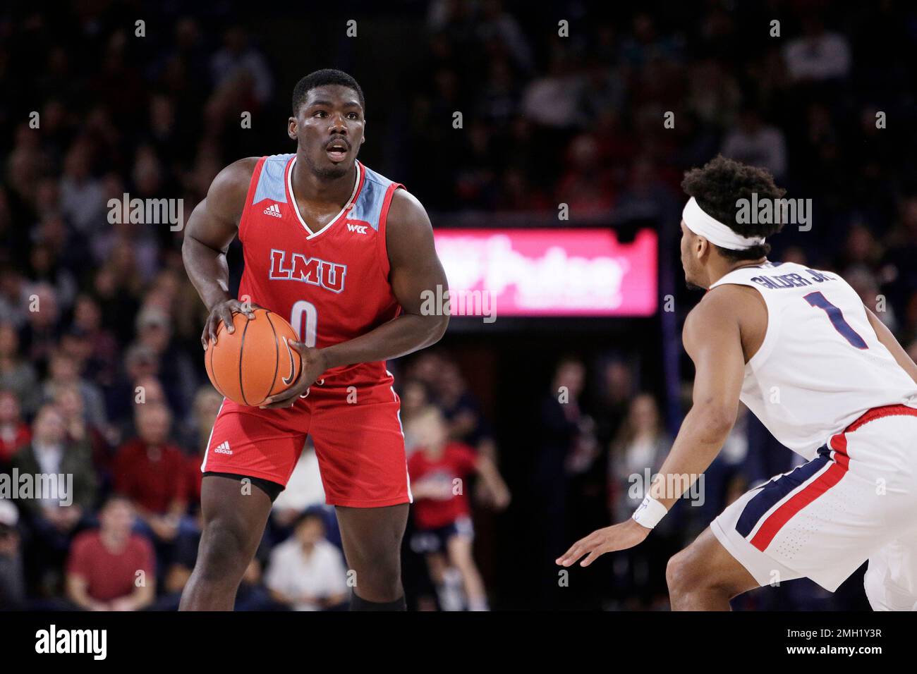 Loyola Marymount guard Eli Scott (0) looks to pass while defended by ...