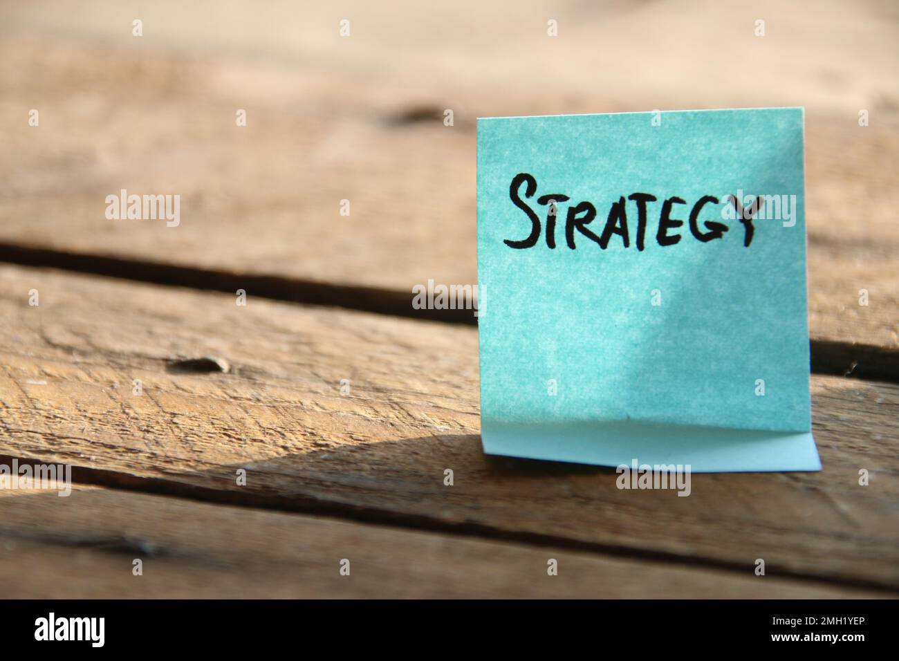 Strategy concept The inscription on the blue tag Stock Photo - Alamy