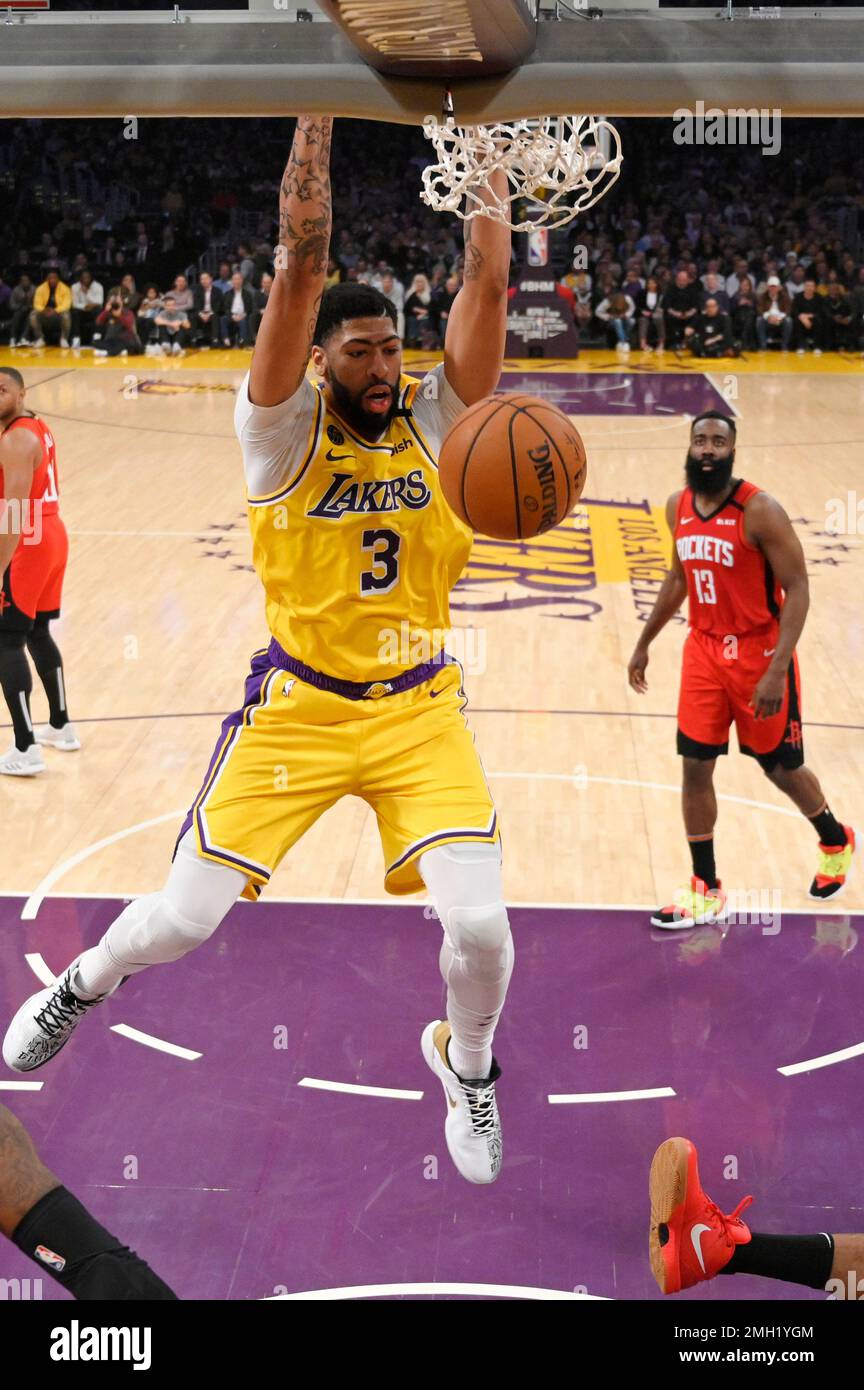 Los Angeles Lakers forward Anthony Davis dunks as Houston Rockets guard ...