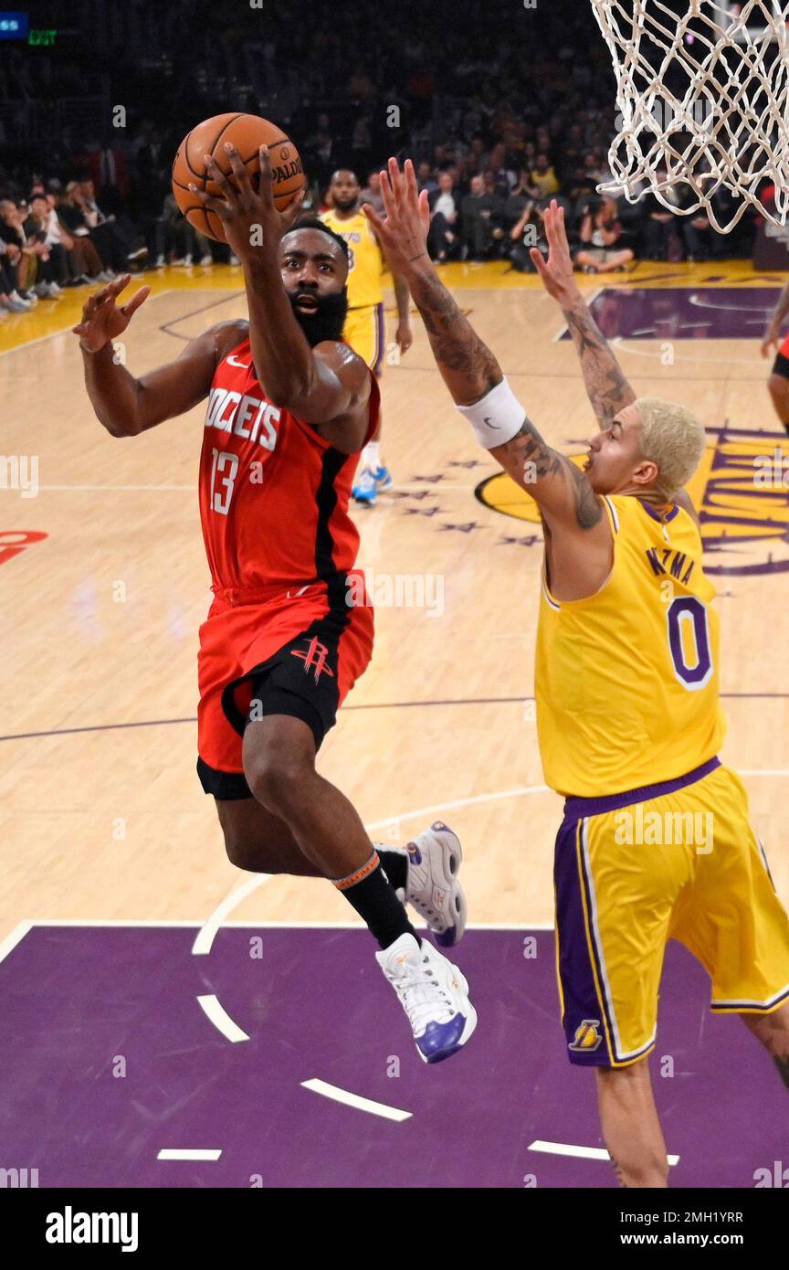 Houston Rockets guard James Harden, left, shoots as Los Angeles Lakers ...