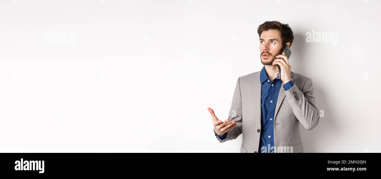 Businessman making phone call, talking on smartphone and looking busy ...