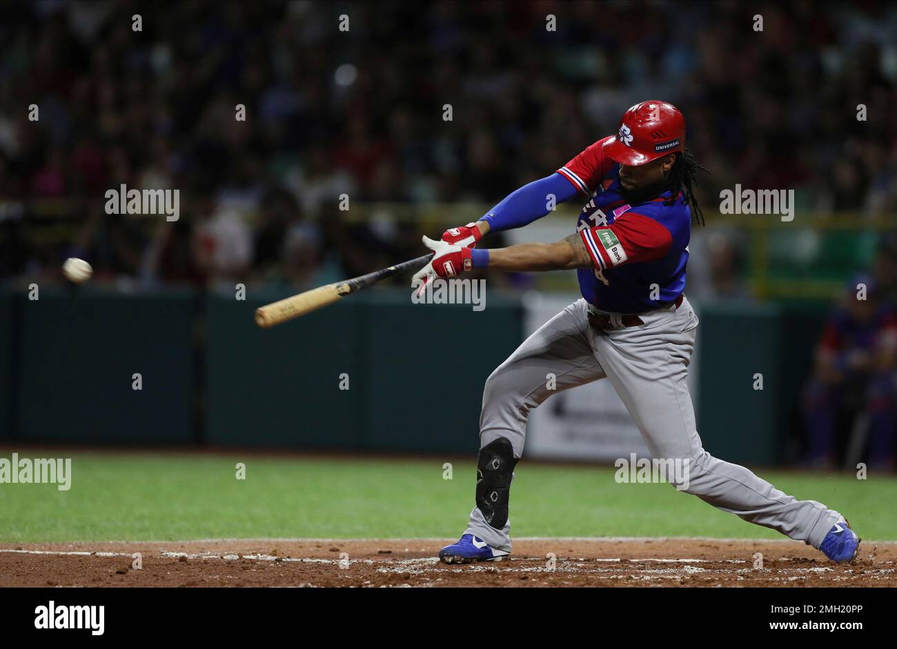Puerto Rico's Henry Ramos connects a single against the Dominican ...