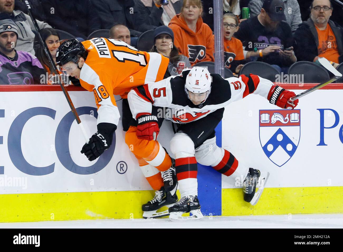 New Jersey Devils' Connor Carrick, right, collides with Philadelphia ...