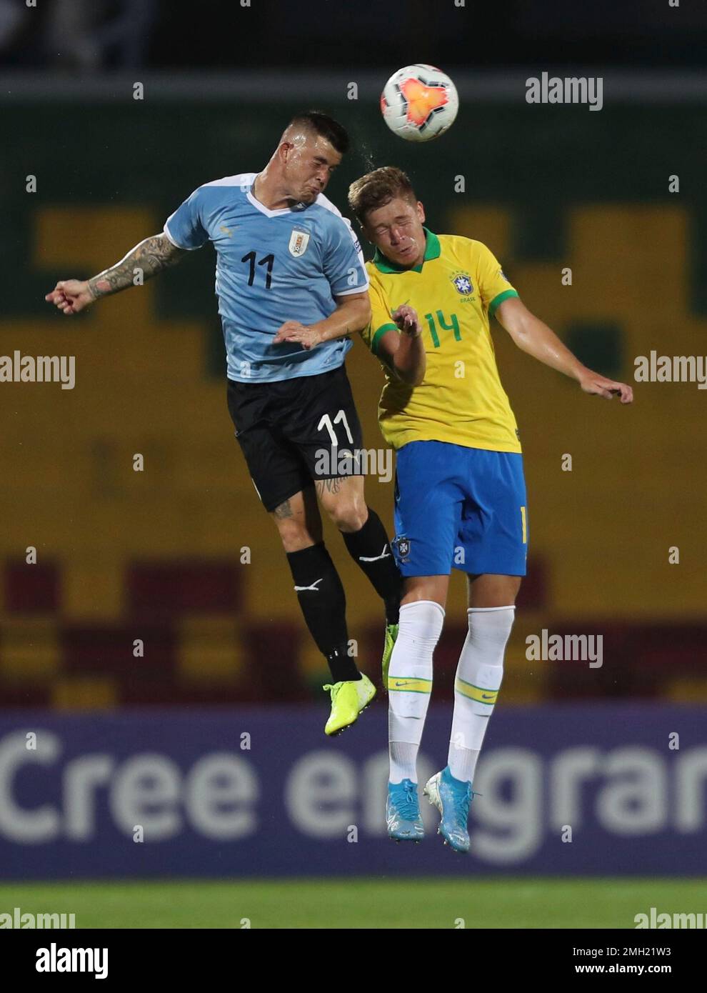 Uruguay's Juan Ramirez, left, and Brazil's Bruno Fuchs jump for a ...