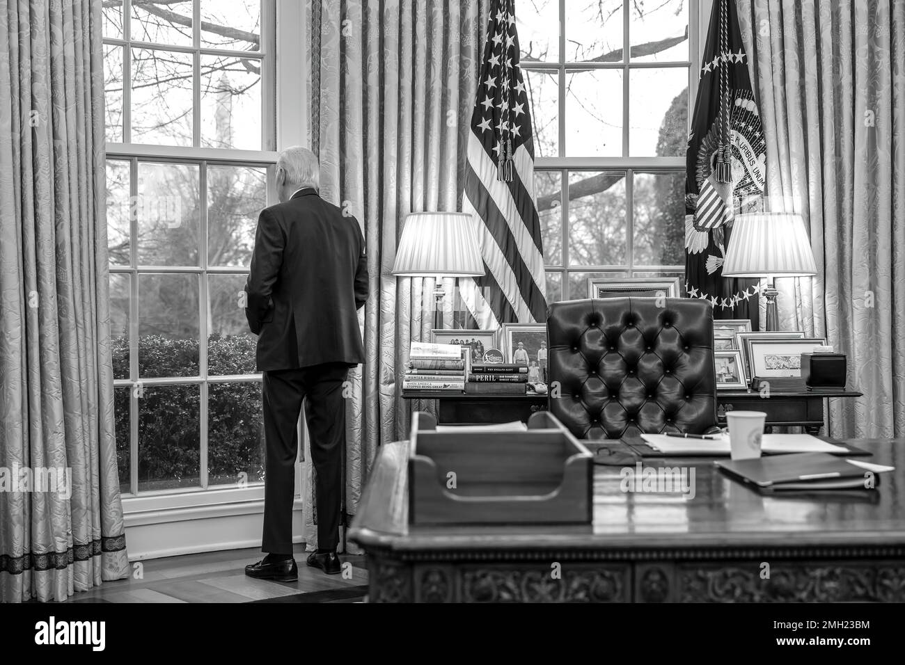 President Joe Biden looks out the window during a phone call with ...