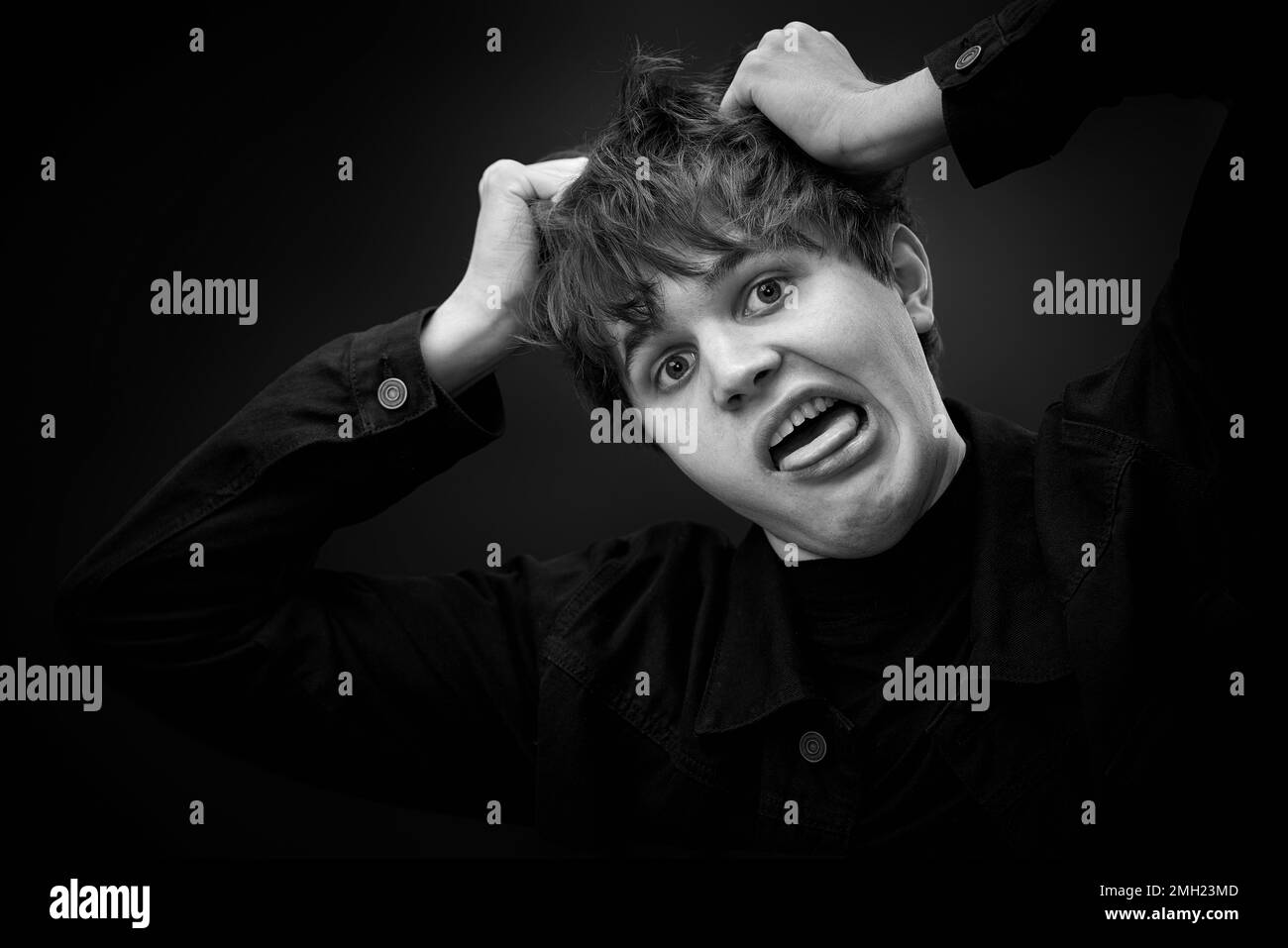 portrait of crazy young man showing the tongue Stock Photo - Alamy