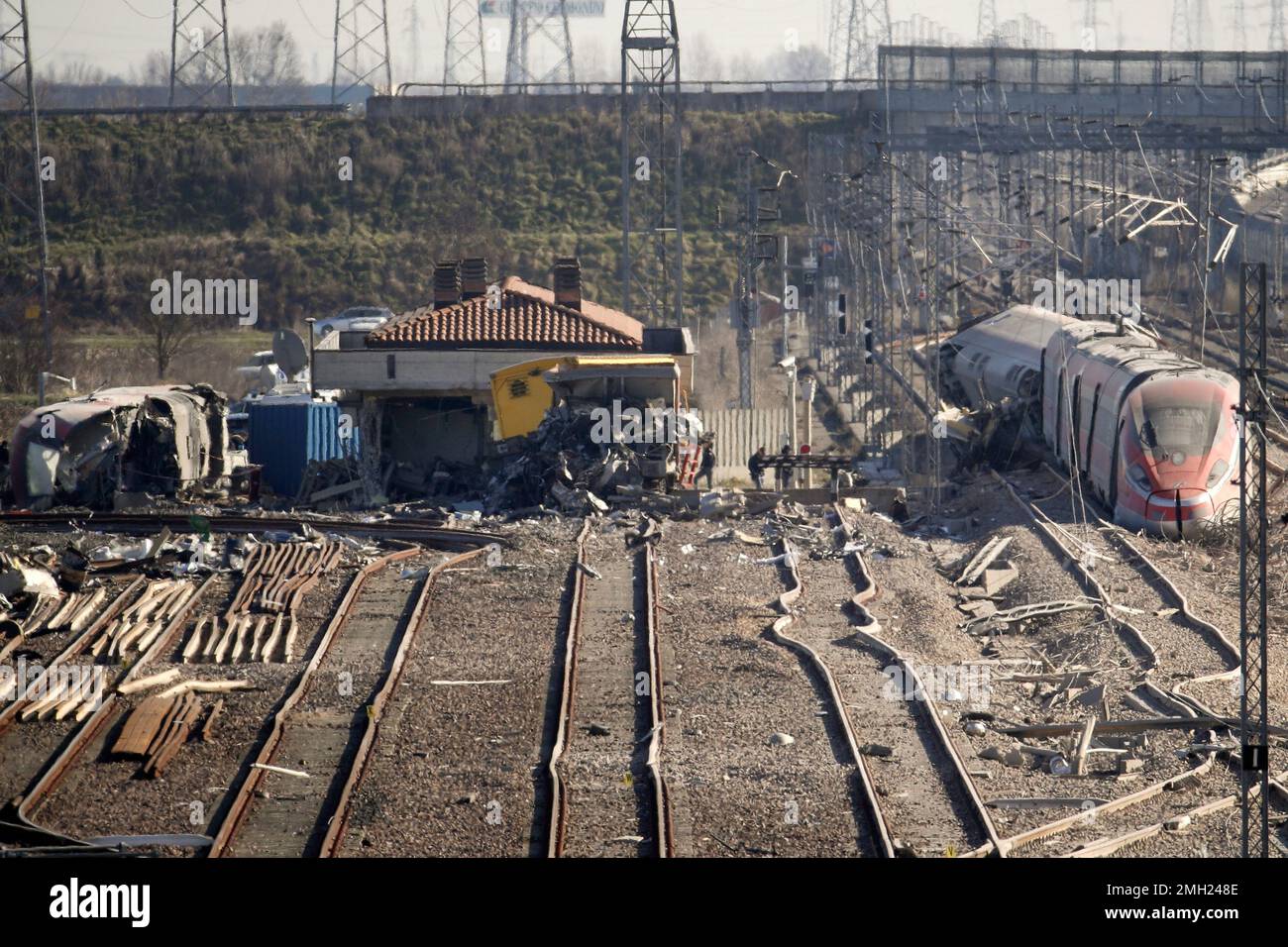 A derailed train engine car is seen at left as the train passenger ...