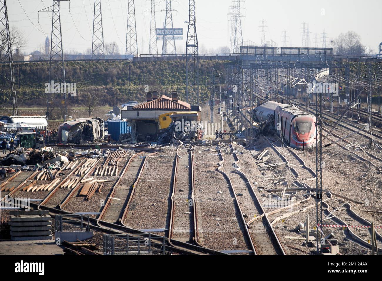 A derailed train engine car is seen at left as the train passenger ...