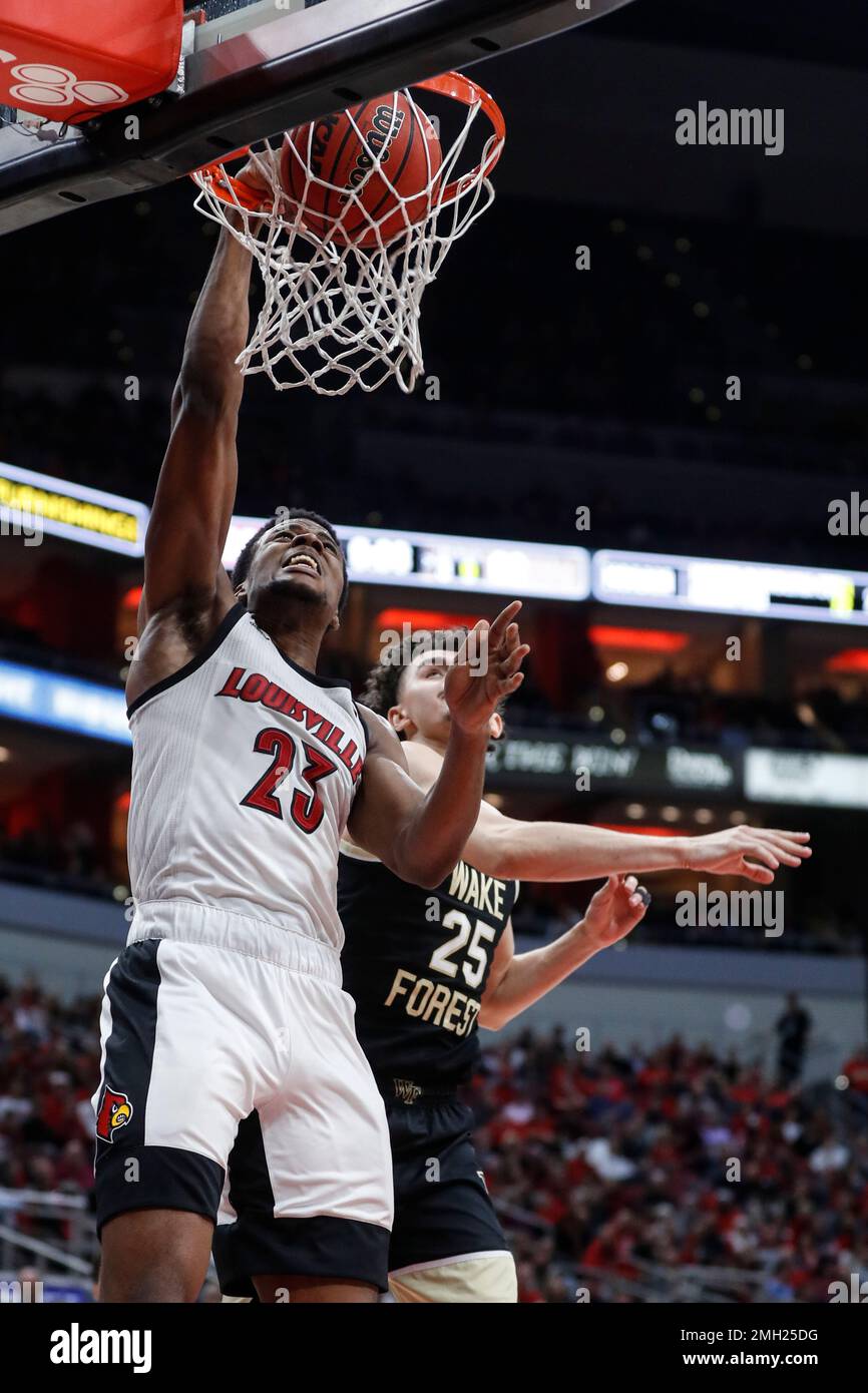 Louisville center Steven Enoch (23) dunks past Wake Forest forward ...